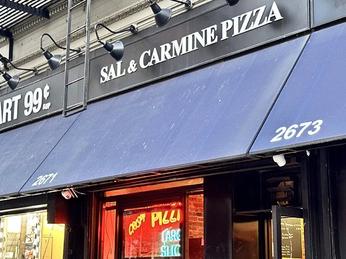 The "LARGE SLICE" neon glows like a promise in Sal & Carmine's window—pizza poetry in just two words.