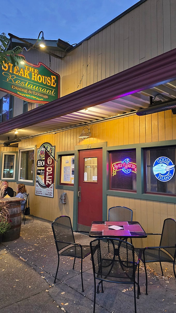 Neon signs glow in the windows as evening falls on The Steak House. Inside, generations of steak expertise await hungry visitors.