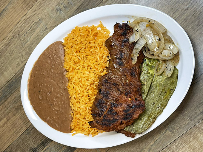 The arrachera plate: where perfectly grilled steak meets colorful sides. This isn't just dinner—it's a vacation for your taste buds without leaving Iowa.
