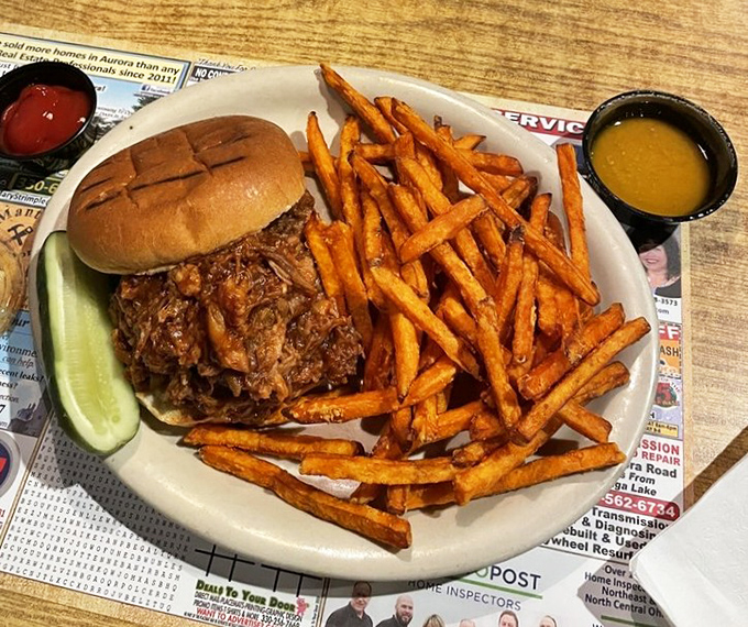 A pulled pork sandwich with sweet potato fries that makes you want to call your out-of-town friends just to brag about what they're missing.