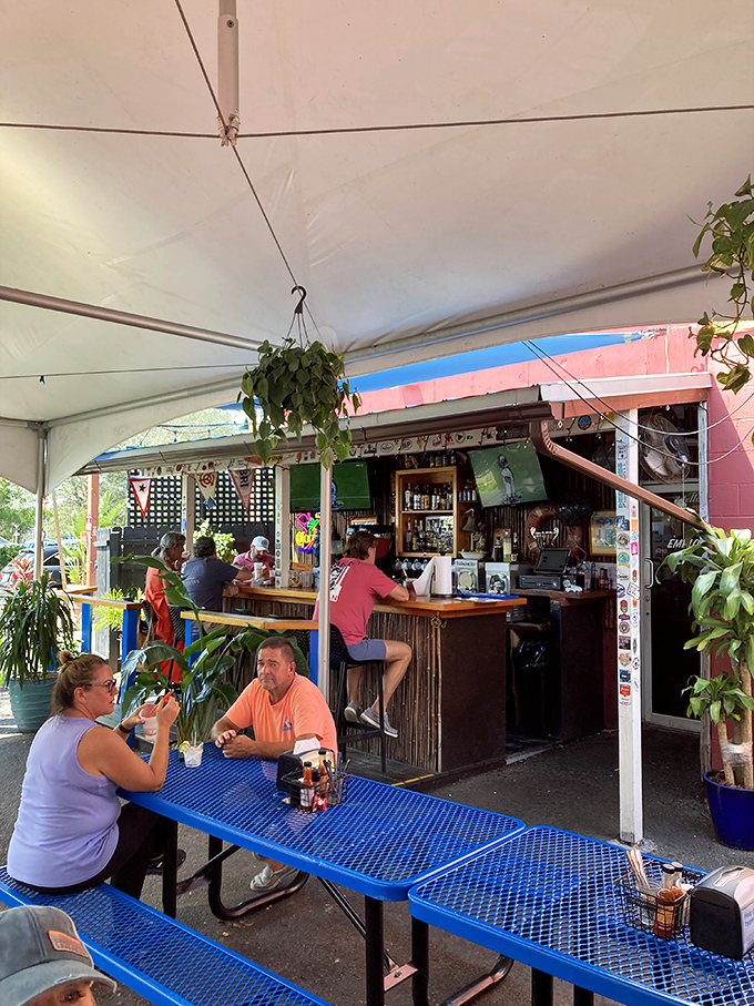 The outdoor bar area—where island breezes meet barbecue smoke in a vacation-worthy marriage of atmosphere and flavor.