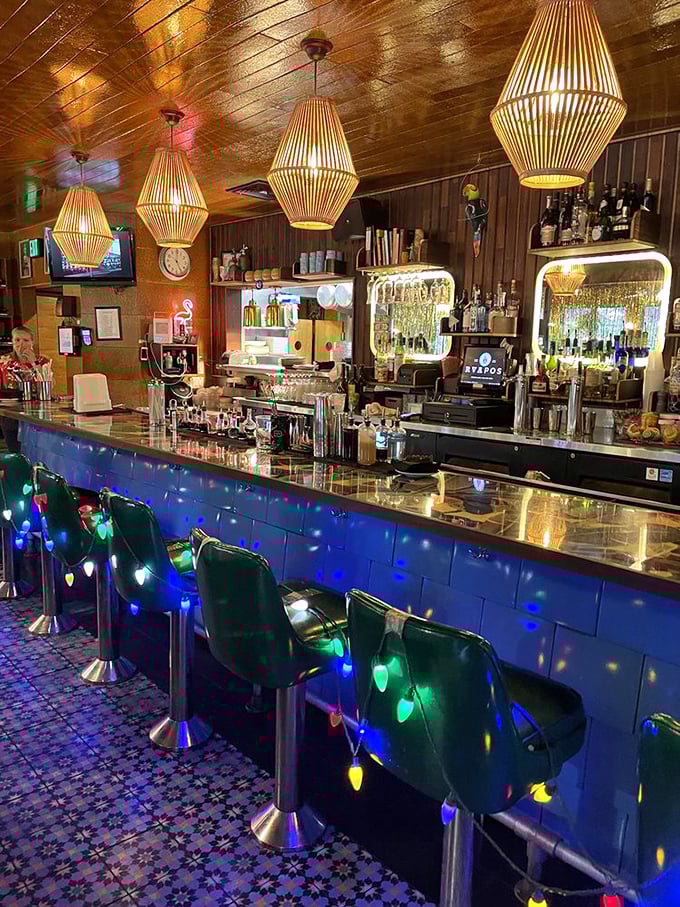 Bar stools wrapped in Christmas lights under bamboo pendant lamps? This bar doesn't just serve drinks—it serves experiences.