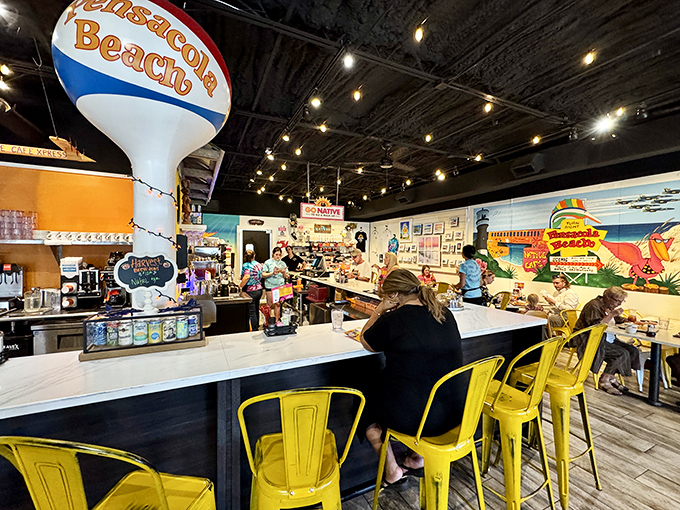 Yellow bar stools and a water tower replica—because nothing says "coastal casual" like primary colors and whimsical local landmarks.