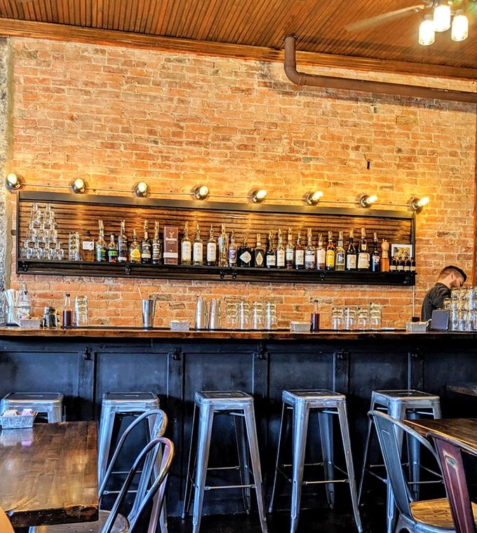 The bar area—where morning coffee transitions to evening cocktails with the same attention to detail. Those bottles aren't just for show.