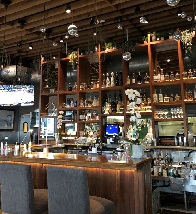 A back bar stocked like a liquid library, where mixologists craft concoctions worthy of their seafood counterparts.