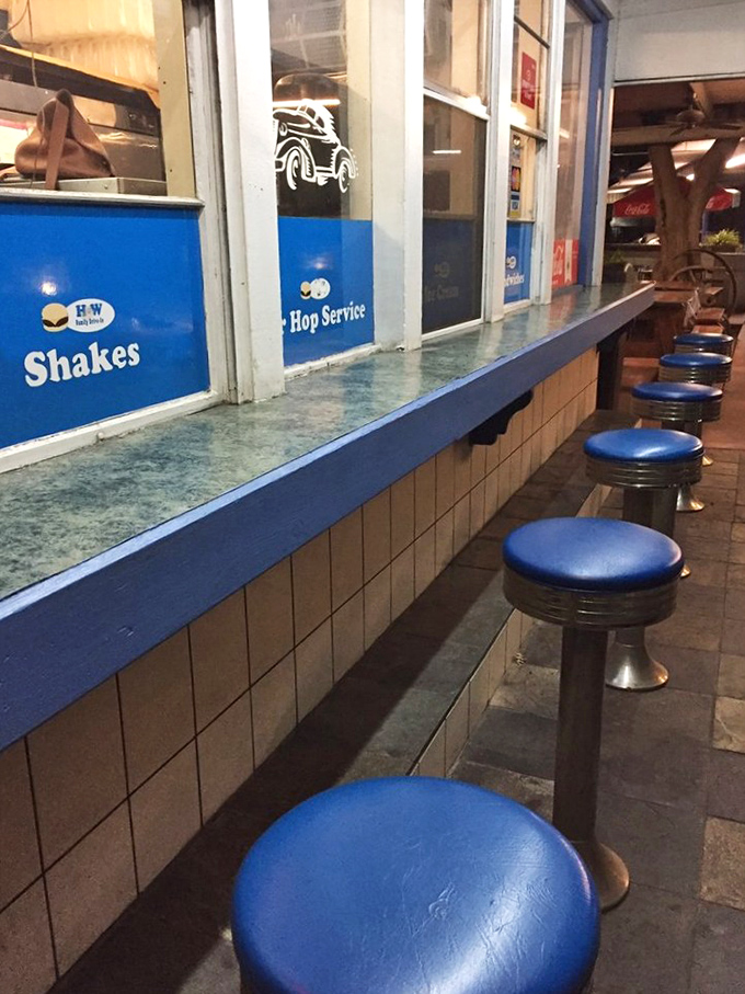 Classic blue counter stools await your presence—the perfect perch for people-watching while contemplating your next bite.