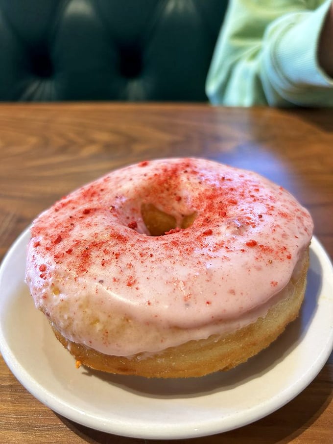 This donut isn't just breakfast—it's a mood-altering experience. The strawberry glaze sparkles like morning sunshine after a perfect night's sleep.