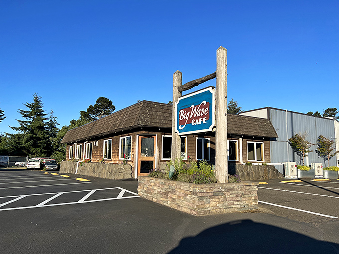 The Big Wave Café embodies coastal architecture at its finest – rustic cedar shingles, stone foundation, and a sign promising seafood stories.