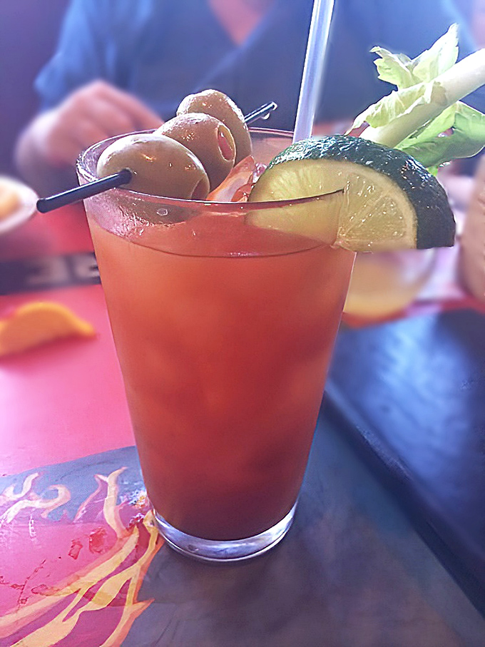 This Bloody Mary isn't just garnished—it's landscaped. A meal in itself with olives standing at attention like they're guarding liquid treasure.