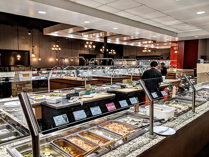 The buffet stations stretch out like a food runway, where every dish gets its moment to shine under perfectly positioned lighting.