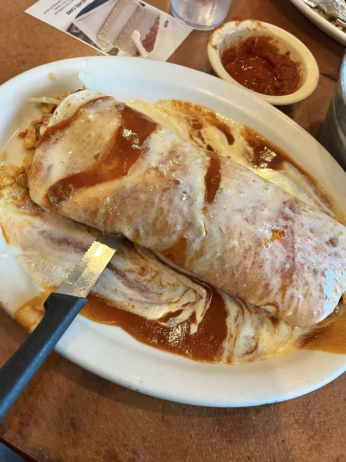 This burrito isn't just large—it's life-affirming. Wrapped in a flour tortilla and drenched in sauce that makes you want to high-five the chef.