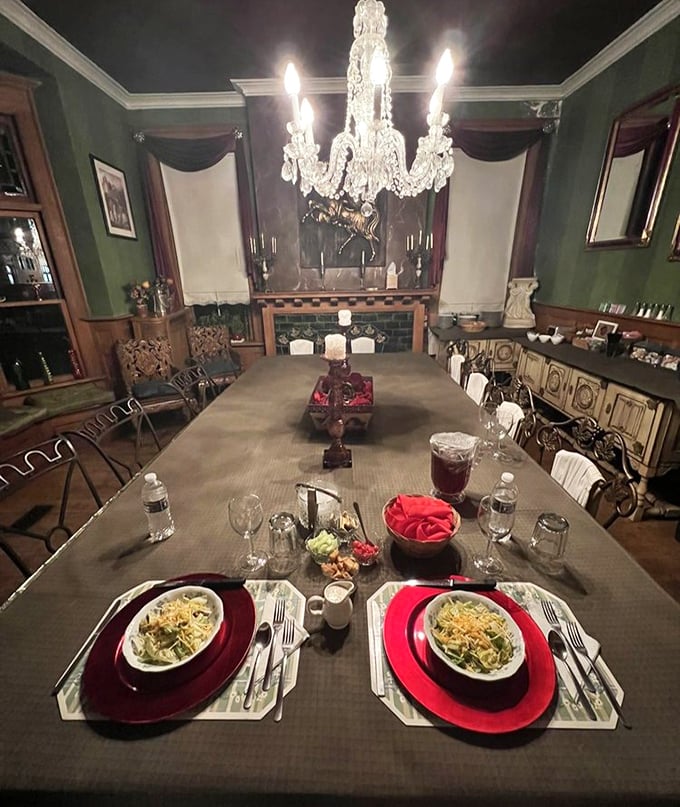 Dinner by chandelier light with burgundy accents—the kind of intimate setting where proposals happen and anniversaries are celebrated.