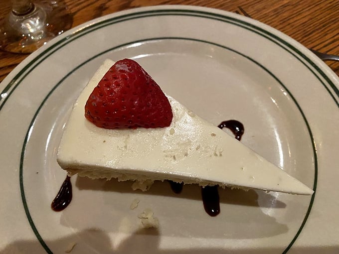 A slice of cheesecake so pristine and perfect, it looks like it's posing for its driver's license photo—if driver's licenses captured pure deliciousness.