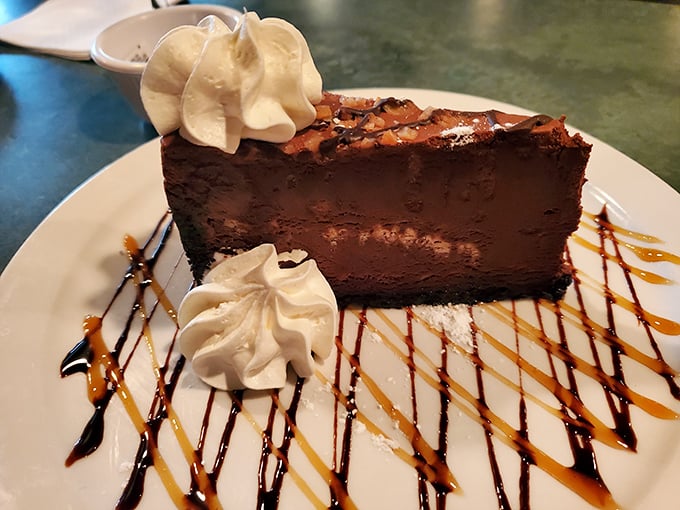A chocolate dessert so decadent it should come with its own pardon form. Those whipped cream dollops aren't garnish—they're essential supporting characters.