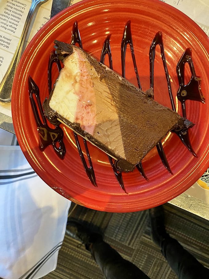 Layer upon layer of chocolate decadence drizzled with sauce—a dessert that doesn't just end a meal, but creates a grand finale.
