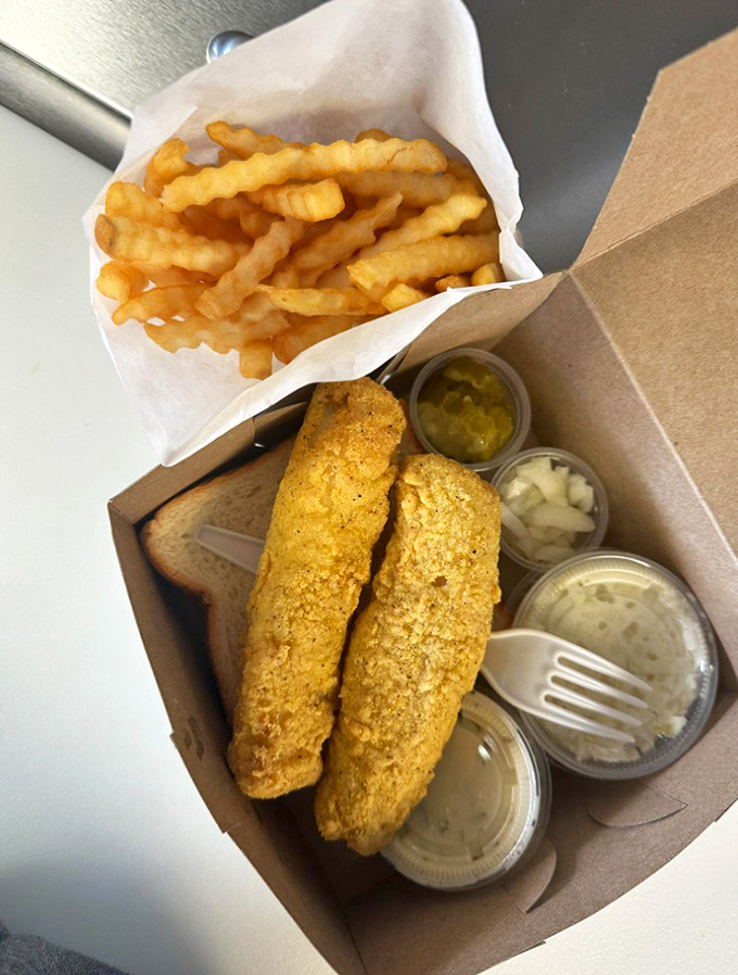 The fish dinner comes with all the fixings in neat little containers, like a perfectly organized picnic that someone else prepared.