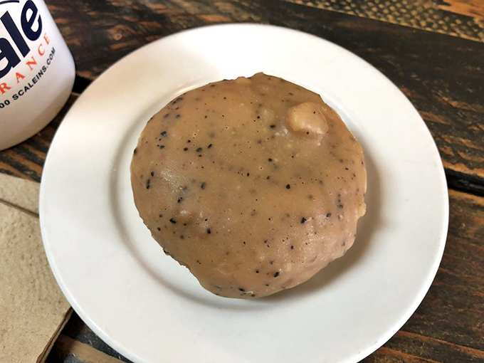 This coffee-studded donut sits like a planet of possibility – those little specks are flavor meteors waiting to hit your taste buds.