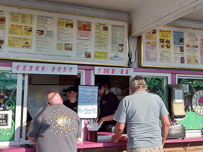 Order here, pick up there—the simple choreography of drive-in dining that's been perfecting the art of fast-but-not-too-fast food for generations.