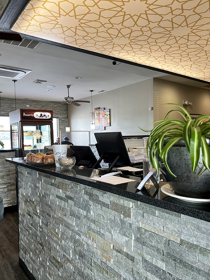 The host station doubles as dessert display central—strategic placement that ensures you'll never leave without considering something sweet for the road.