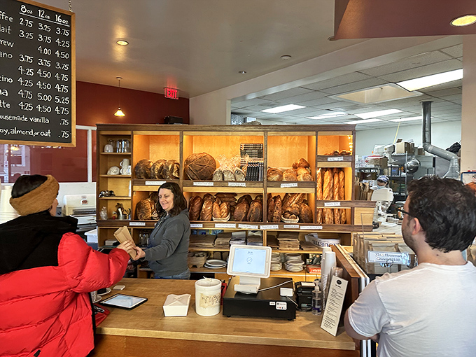 Behind the counter, where bread dreams become reality. Those loaves aren't just baked—they're crafted with the precision of Swiss watchmakers.