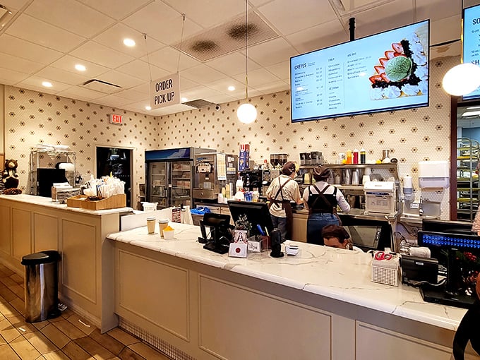 At the counter, pastry meets performance art as staff orchestrate a ballet of boxed cakes and perfect lattes.