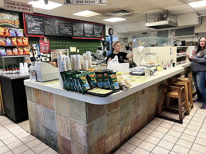 Behind this unassuming counter, sandwich artists work their magic—no berets or paint-splattered aprons, just skilled hands and perfect timing.