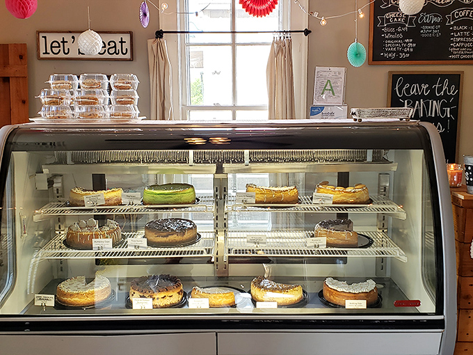 "Let's Eat" indeed – the display case is like an aquarium where cheesecakes swim instead of fish, and you're encouraged to catch your favorite.