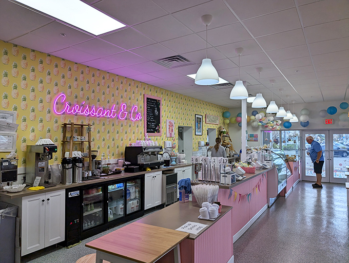 Pink neon against yellow walls – it's not just a bakery, it's a mood. The counter where croissant dreams come true.