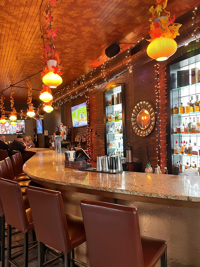 The bar glows with amber lighting and well-stocked shelves—a warm beacon for craft cocktail enthusiasts and those simply needing a good pour. 