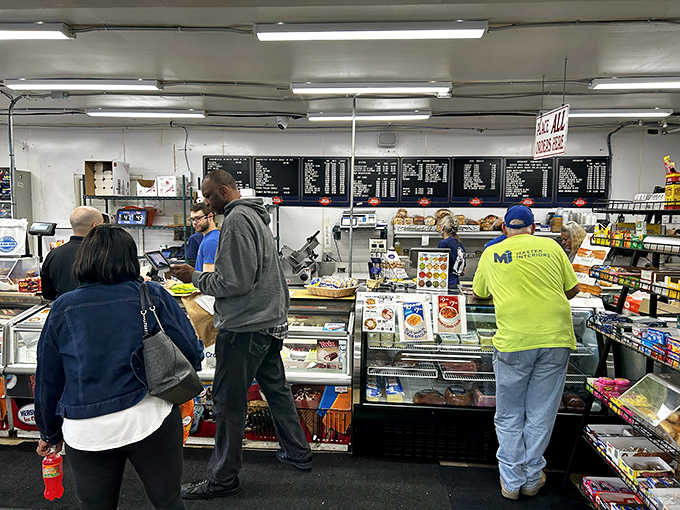 A diverse crowd of customers united by a common purpose: the pursuit of sandwich excellence in its natural habitat.