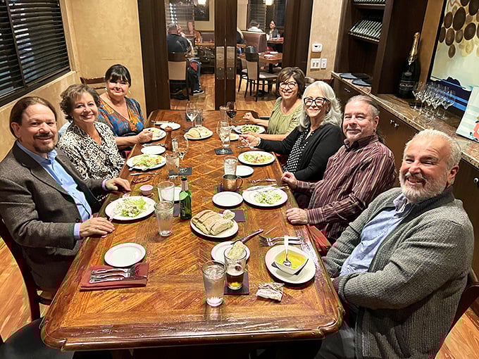Happy diners around a table prove that great food creates the best kind of social gathering.