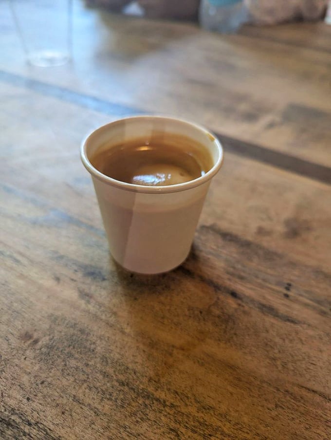 That tiny cup holds liquid ambition—the espresso that powers downtown Greensboro one caffeinated sip at a time. Small but mighty indeed.