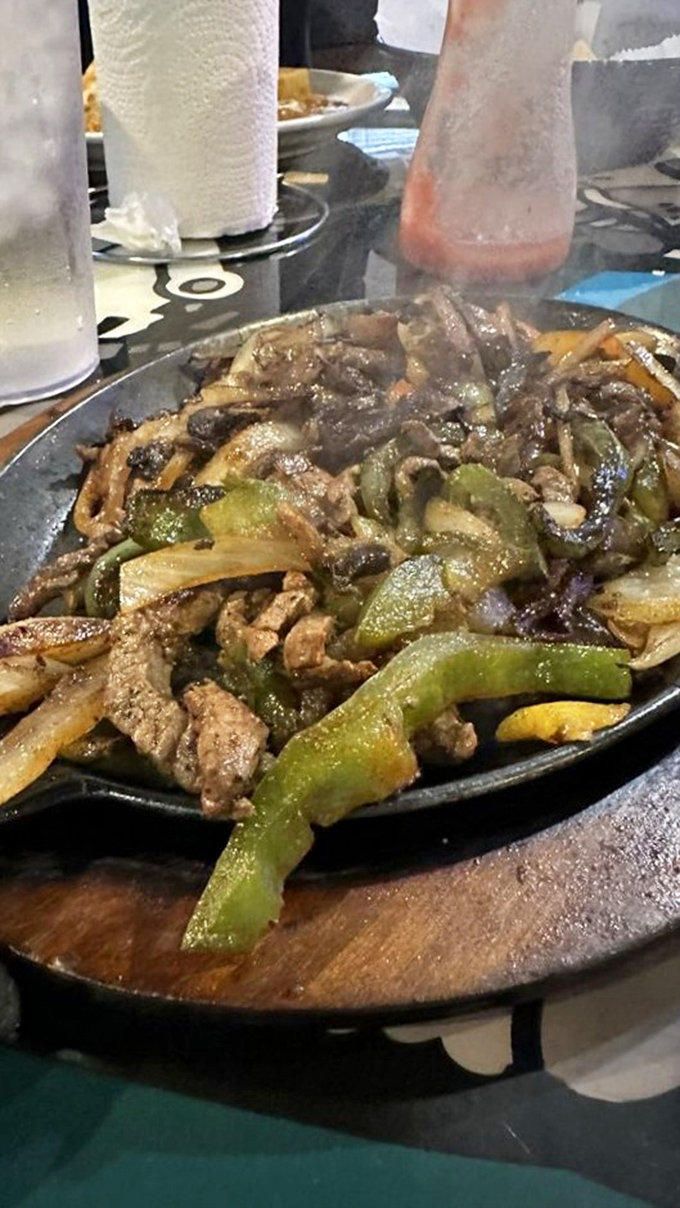 The sizzle announces its arrival before you see it. This fajita platter doesn't just satisfy hunger—it creates memories.