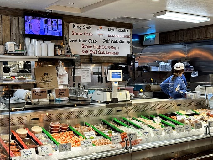 The fish market display case—where tomorrow's dinner sleeps on ice while today's lunch swims in your stomach just yards away.