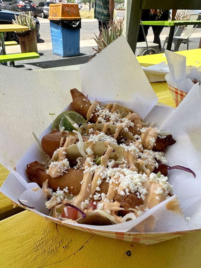 Fish tacos served in paper boats – appropriate since these flavors will sail you straight to coastal bliss.