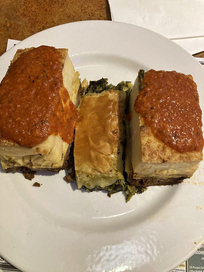 Greek spanakopita squares topped with marinara – a Mediterranean vacation for your taste buds without leaving Delaware County.