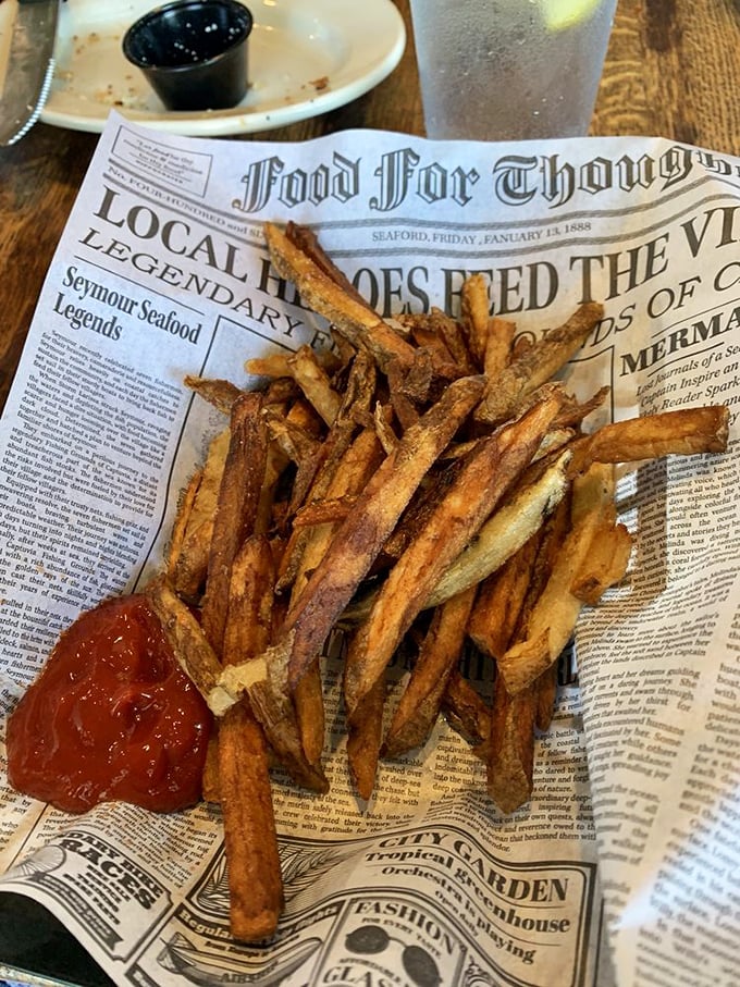 Fries served on vintage newspaper—a delicious history lesson where the only required reading is "eat me immediately."