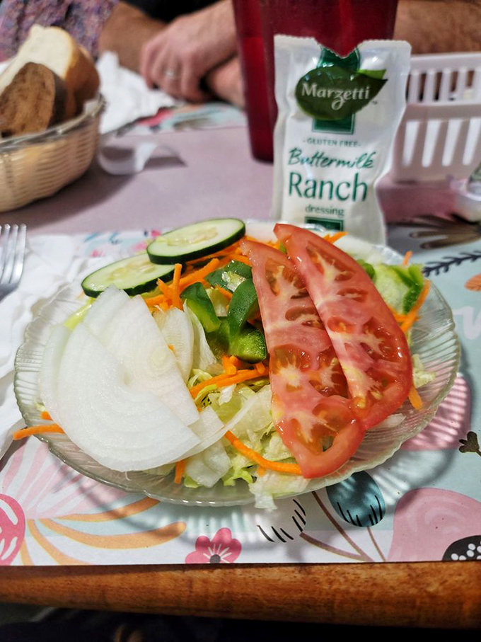 A house salad that keeps it honest—fresh, crisp, and ready to provide the illusion that you're making healthy choices.