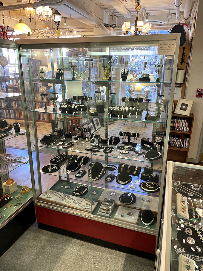 Gleaming estate jewelry displayed under glass—each piece with its own secret history of special occasions, celebrations, and perhaps a touch of scandal.