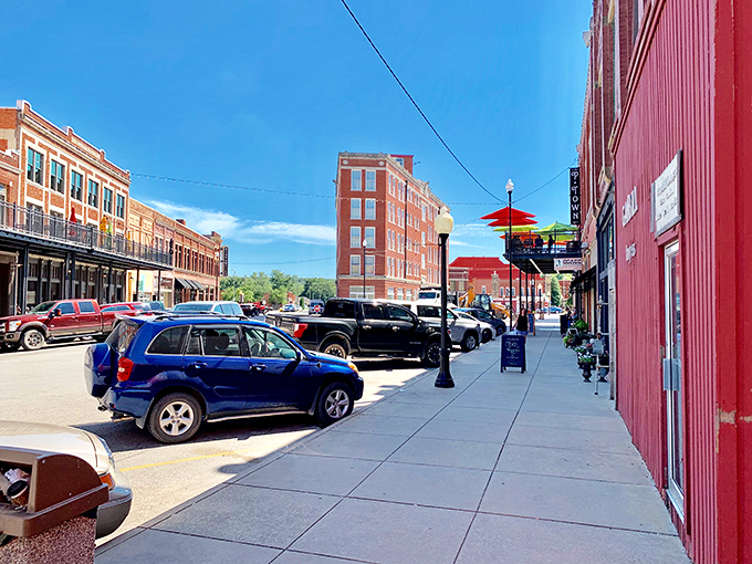Colorful umbrellas dot the sidewalks of Kihekah Avenue, where brick buildings frame a perfect small-town shopping scene.