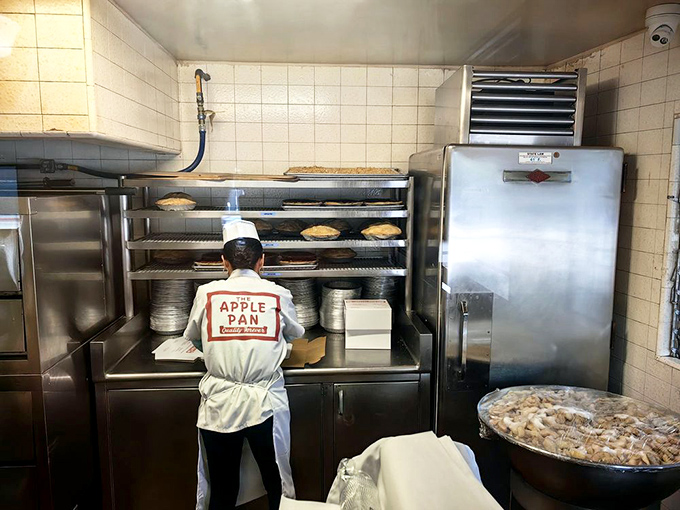 Behind the scenes, where the magic happens – pies cooling on racks while staff members maintain traditions older than most Hollywood franchises.