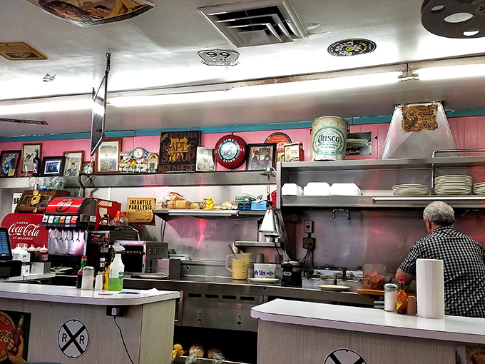 Where the magic happens – vintage signs watch over the grill as breakfast classics come to life. The kitchen's heartbeat is almost audible.