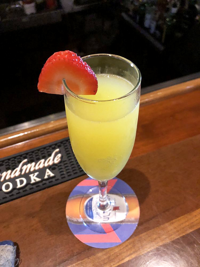A mimosa garnished with strawberry—because vitamin C should always wear a little red dress. Brunch in a glass, Florida-style.