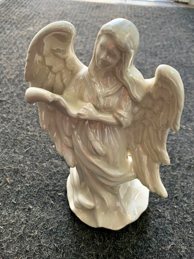 This pearlescent angel figurine isn't just decor—it's someone's former guardian of the mantelpiece, ready to watch over a new home.