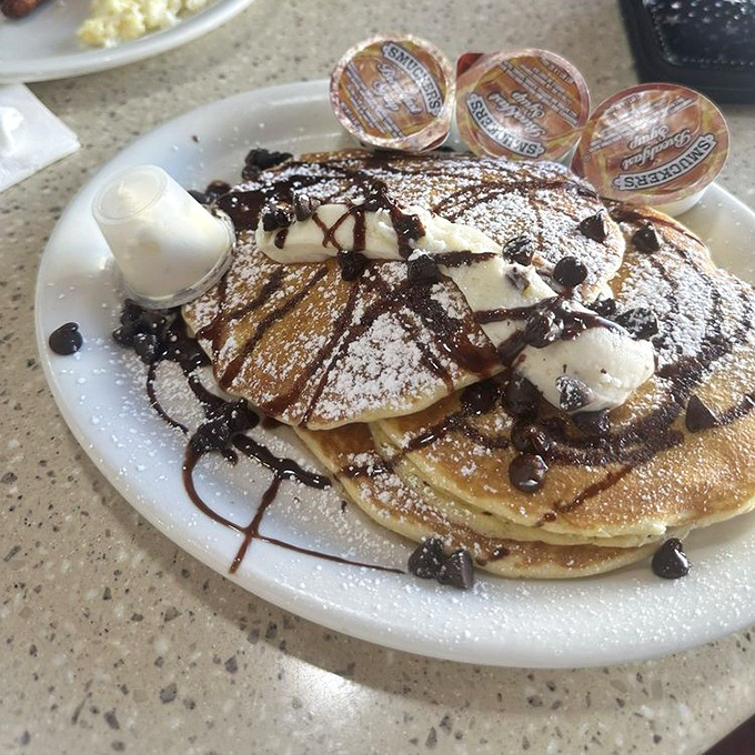 Nutella pancakes topped with whipped cream and chocolate—because sometimes breakfast should feel like you're getting away with something.