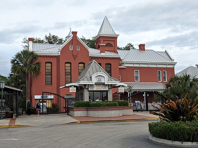 The Old Jail's distinctive red façade belies its serious history—a Victorian-era prison disguised as a hotel to avoid alarming the city's wealthy visitors.