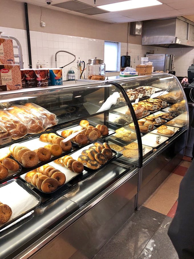 The bakery case—where willpower goes to die and diet plans are forgotten amid the siren call of fresh bagels.