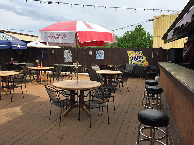 The outdoor patio—where summer evenings stretch longer than your workweek, and cold drinks taste even better under string lights and Missouri skies.