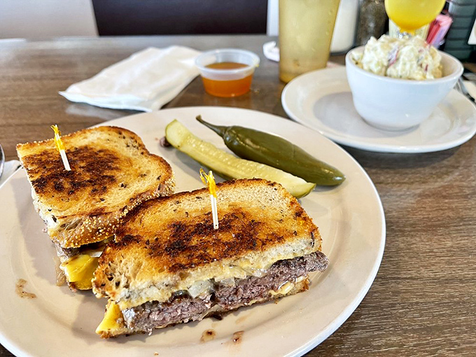 The patty melt—that beautiful marriage of burger and grilled cheese that proves sometimes the best innovations happen between two slices of rye.