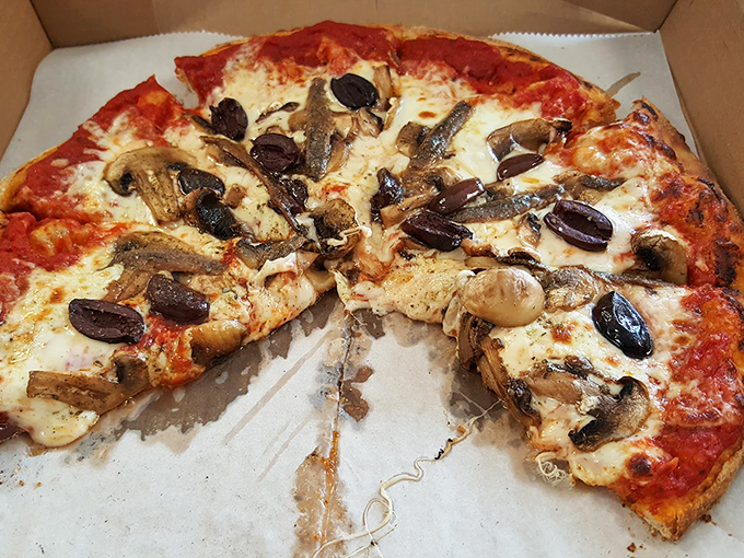 Pizza from a BBQ joint? Trust me on this one—wood-fired crusts and quality toppings make this an unexpected star.
